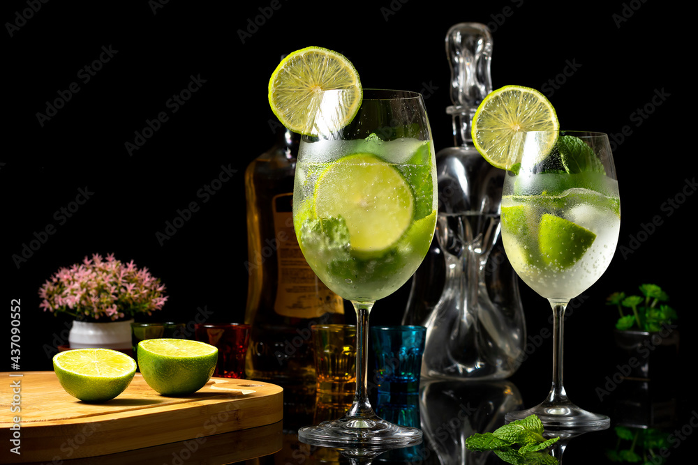 lemon cocktail in a glass goblet on a reflective black background, gin ...