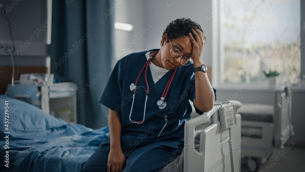 Hospital Ward: Portrait of Sad, Tired Black Nurse Sitting on a Bed ...