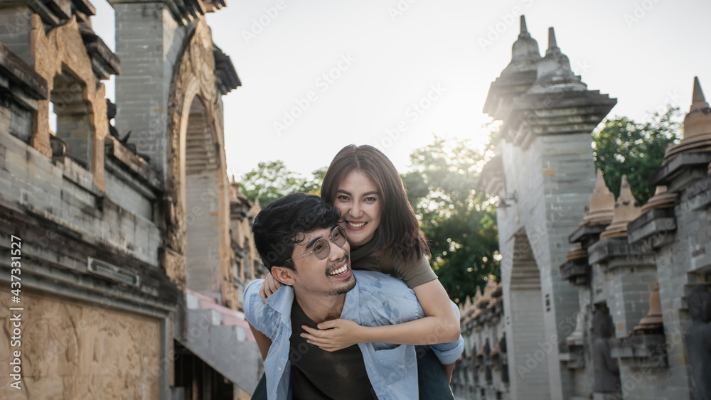 Happy Asian couple traveler, Romantic female riding on back of ...