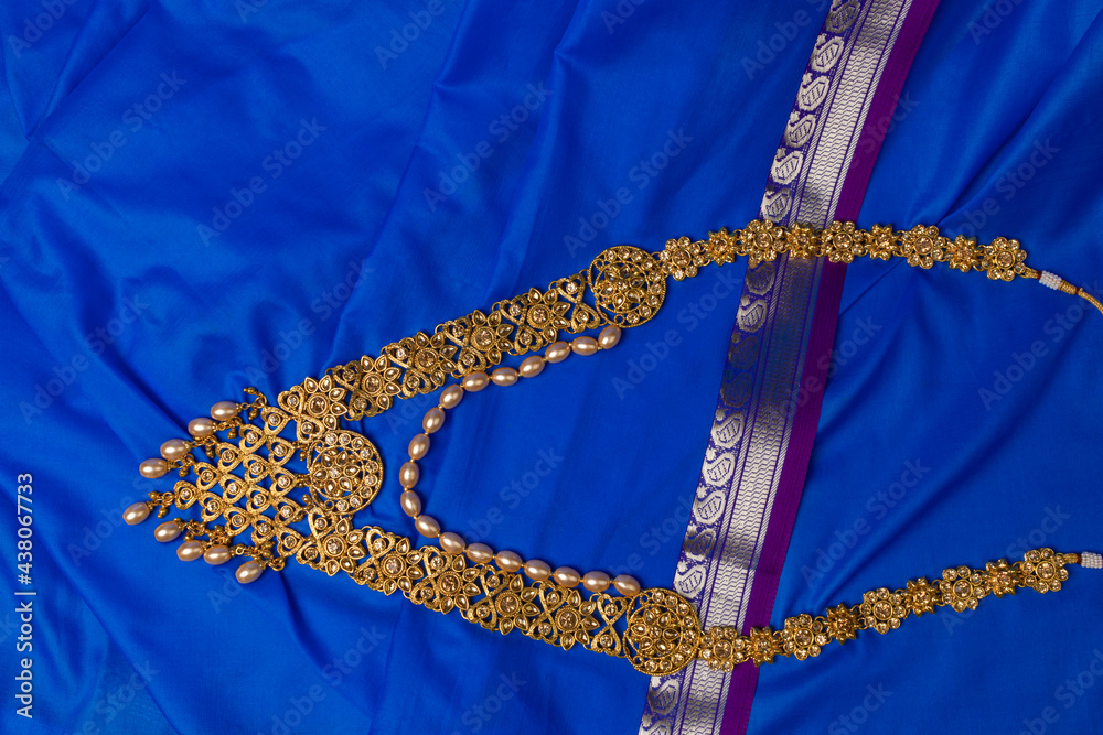 Indian traditional gold Indian wedding women's jewelry on blue saree ...