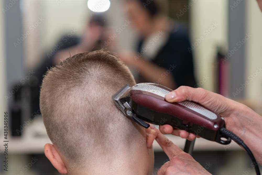 Cute boy have haircut, professional barber doing haircut. Hairdress for ...