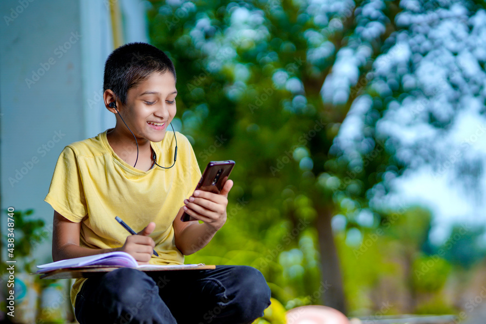 Indian school boy holding phone distance learning class using mobile ...