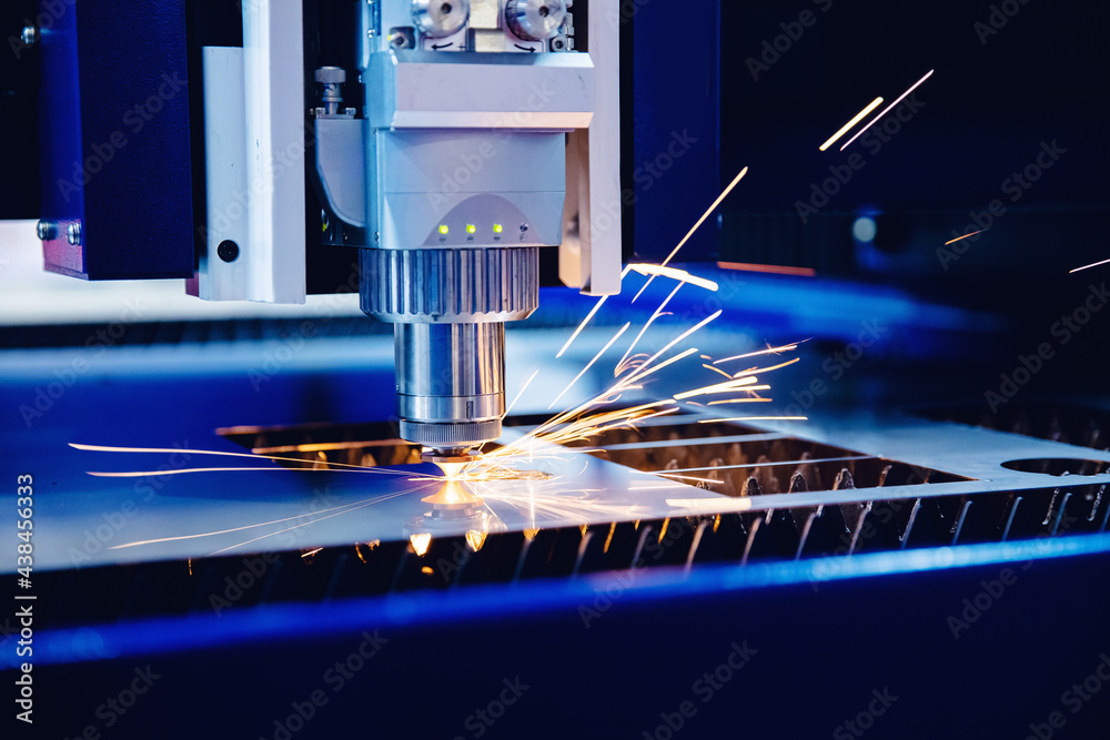 Industrial background CNC laser machine cutting sheet metal with light ...