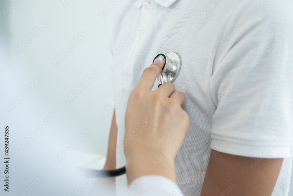 Female doctors perform a pulse examination using a headphone cable ...
