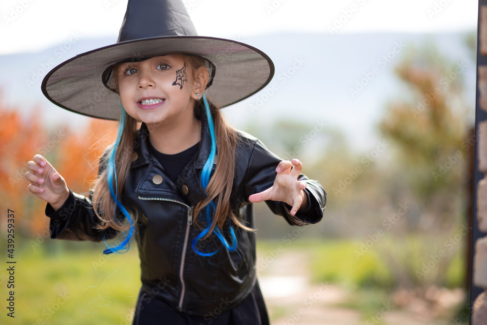 Стокове фото Cute little witch in Halloween. Baby scary facial ...