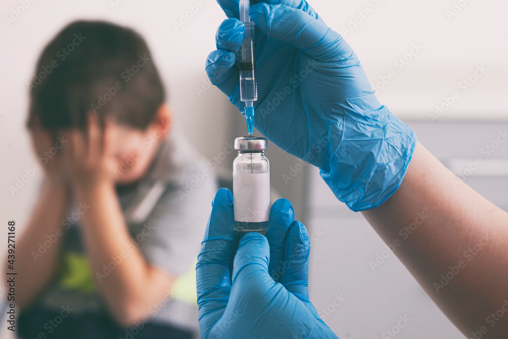 The child fears the injection. Boy covered his face with his hands ...