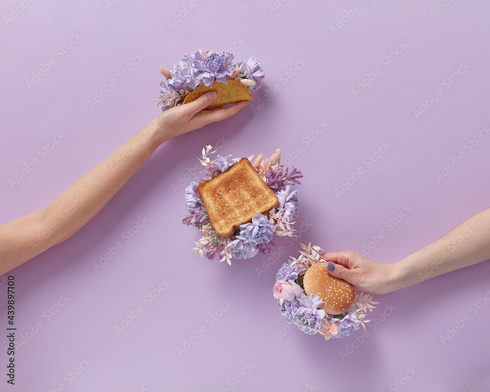 Women holding burger, taco and sandwich with spring flowers Stock Photo ...