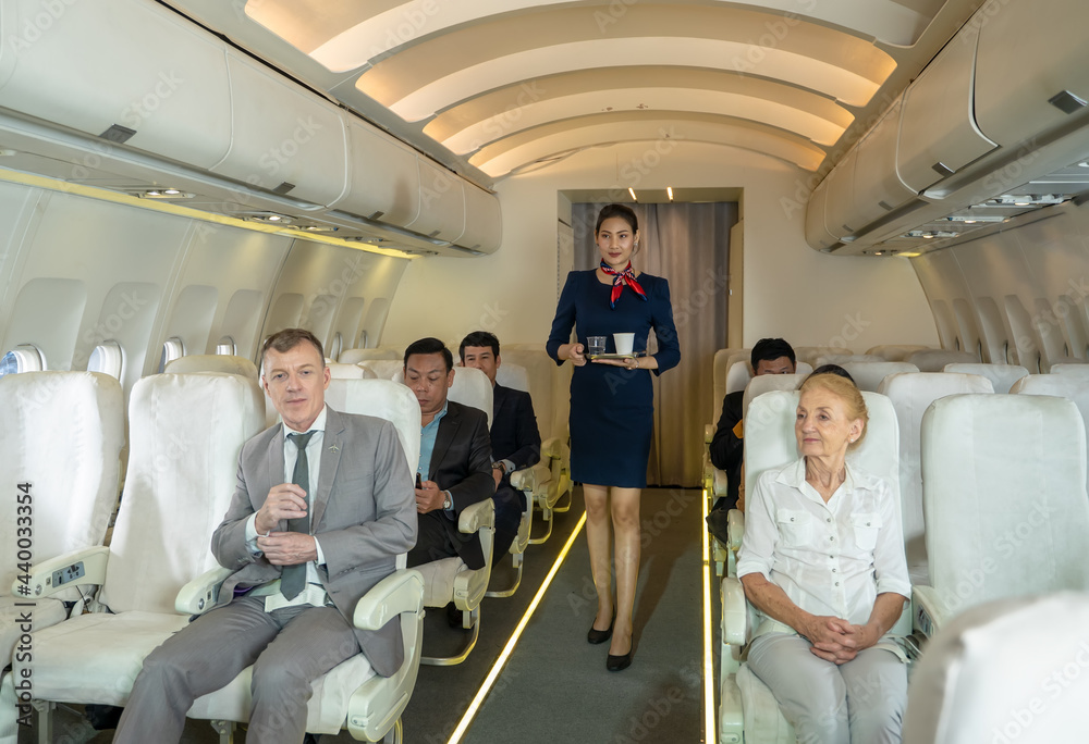 Foto de Stock Flight attendants serve on board,Air hostess serving tea ...