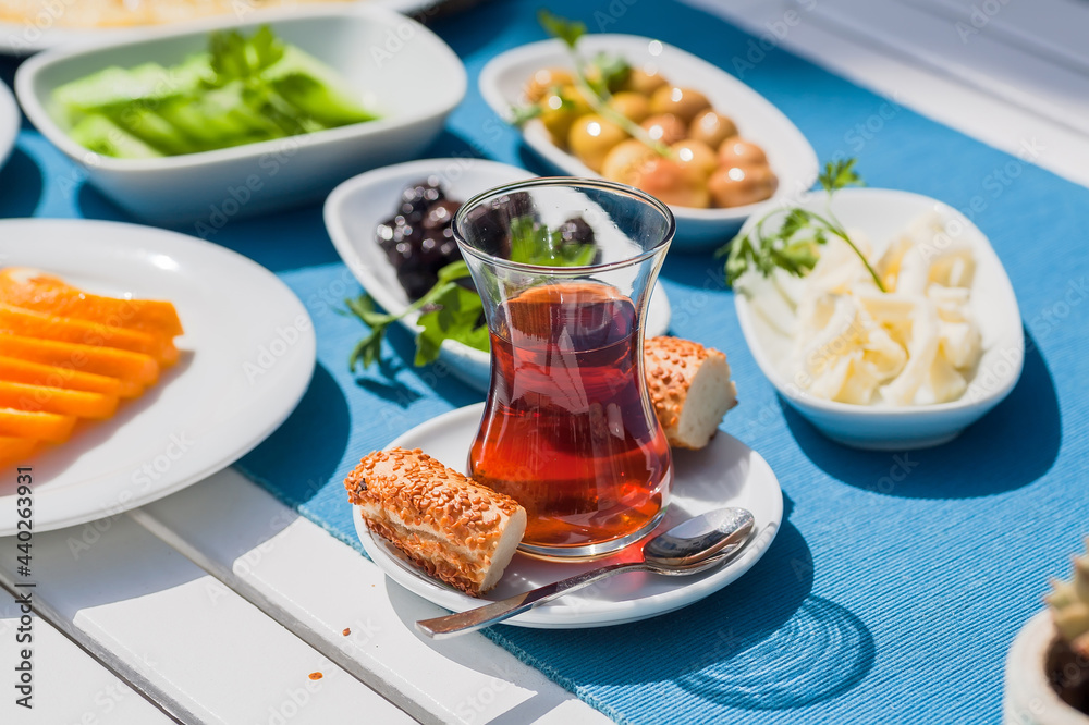 Turkish tea, bread and olives for breakfast. Table with healthy food in ...