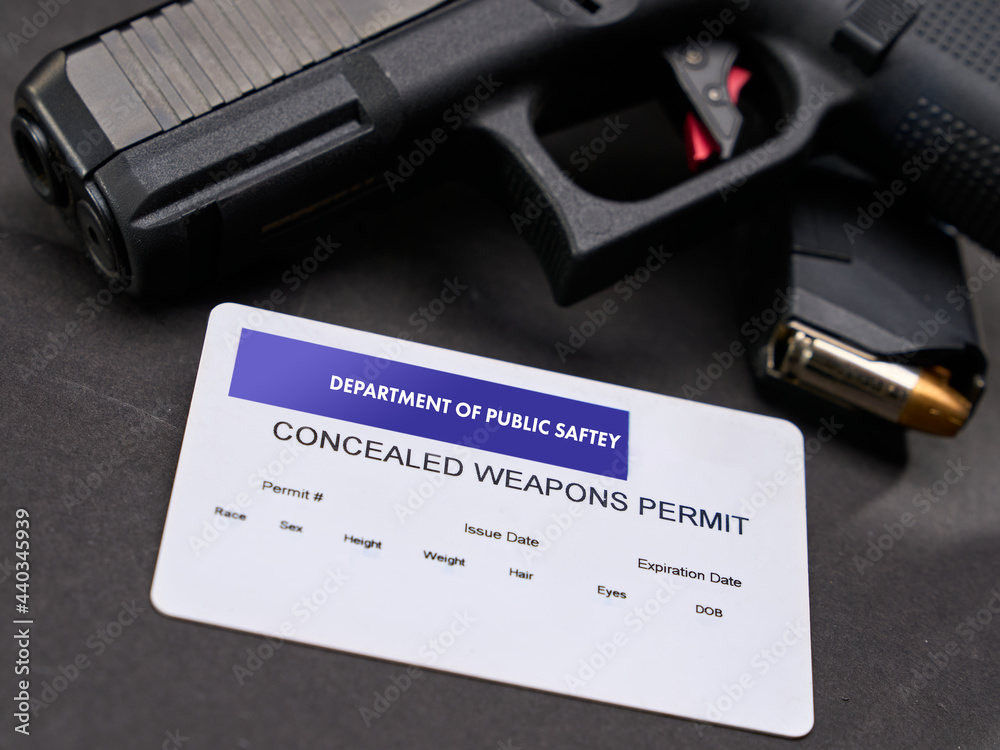 Concealed Carry Permit next to a semi-automatic handgun Stock Photo ...