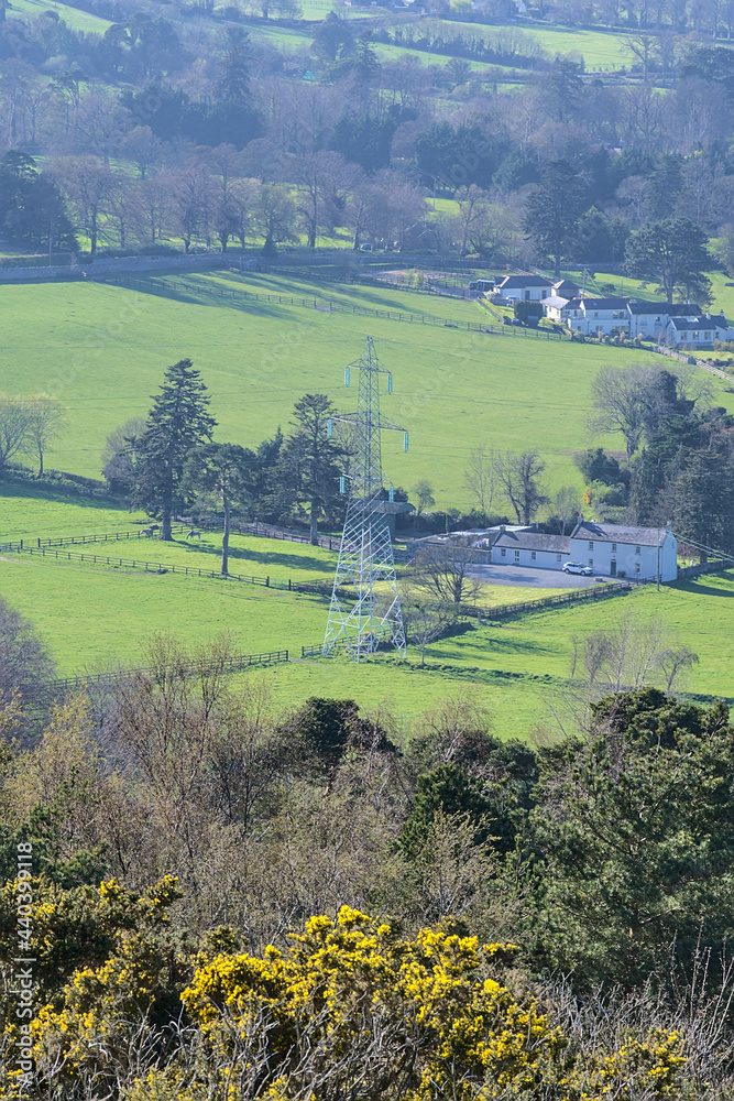 Beautiful bright aerial-like view of green fields, and high voltage ...