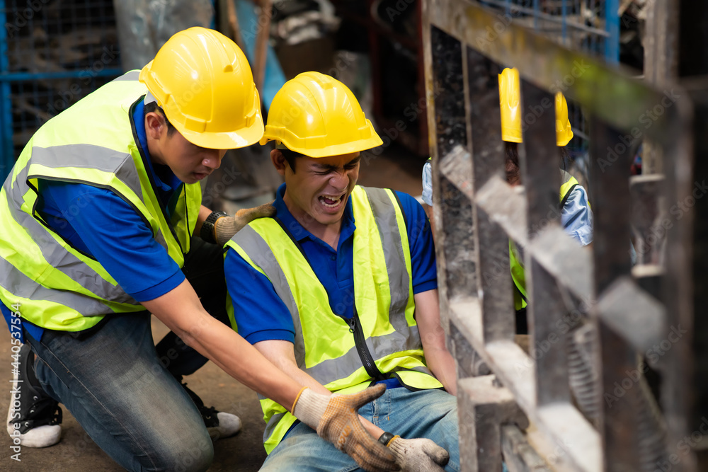 injured Asian man worker after accident in a old car parts warehouse ...