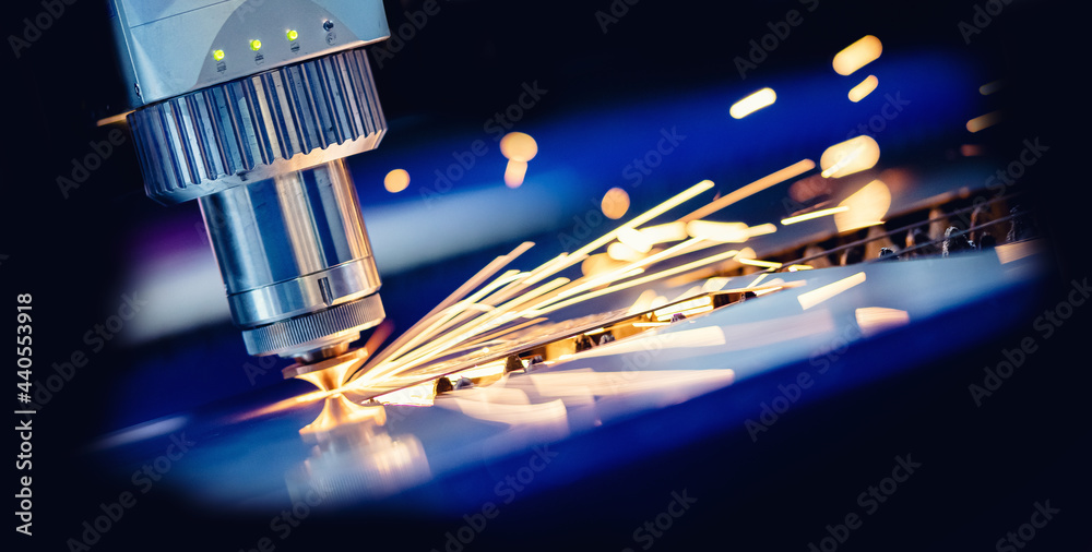 CNC Laser engraving cutting of heavy metal with light spark. Concept ...