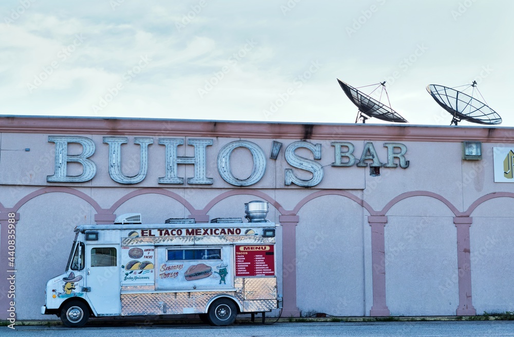 Buho's Bar exterior with a taco truck out front in Houston, TX. Adult ...