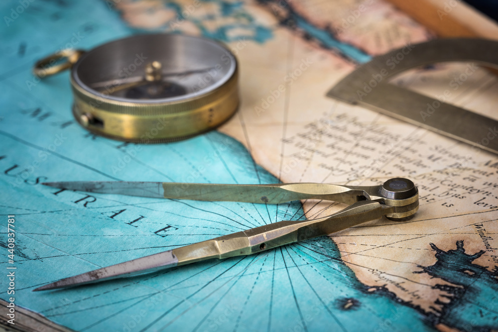 An old geographic map with navigational tools: compass, divider, ruler ...