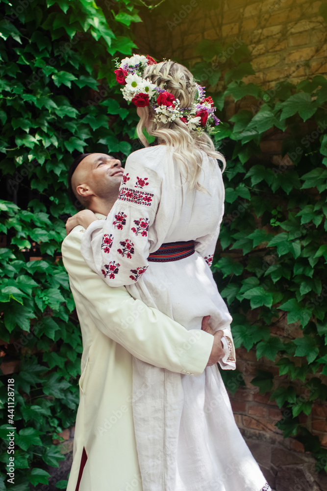 Young people are posing in traditional folk costumes. Cossacks man and ...