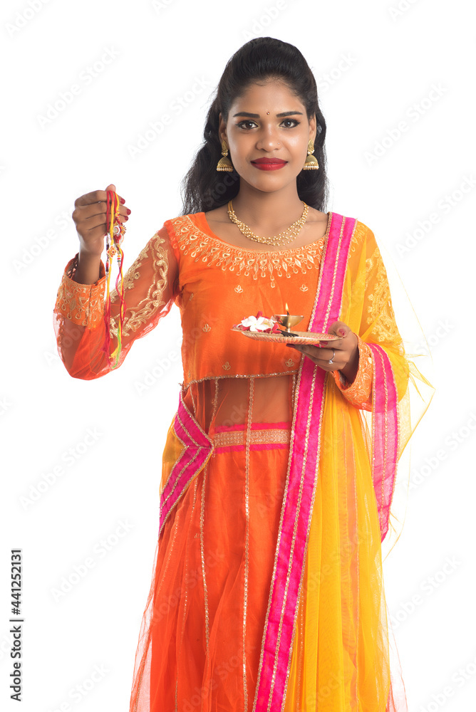 Beautiful Indian girl showing Rakhi with pooja thali on occasion of ...