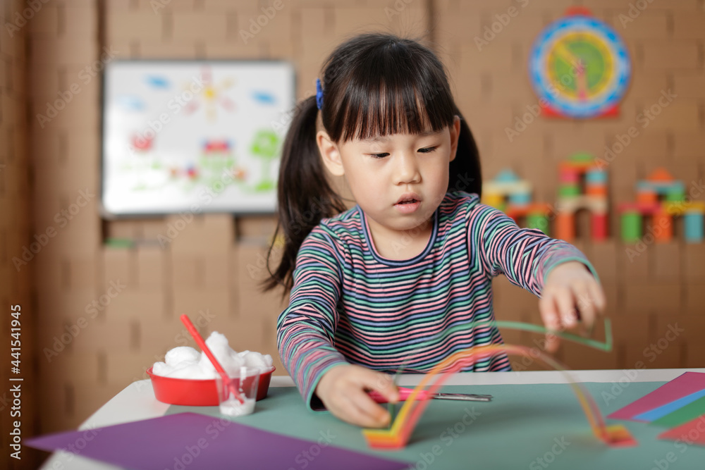 young girl making paper craft for homeschooling Stock Photo | Adobe Stock
