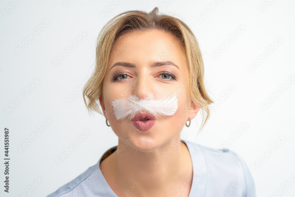 Funny beautician with a white feather-like mustache poses on white ...