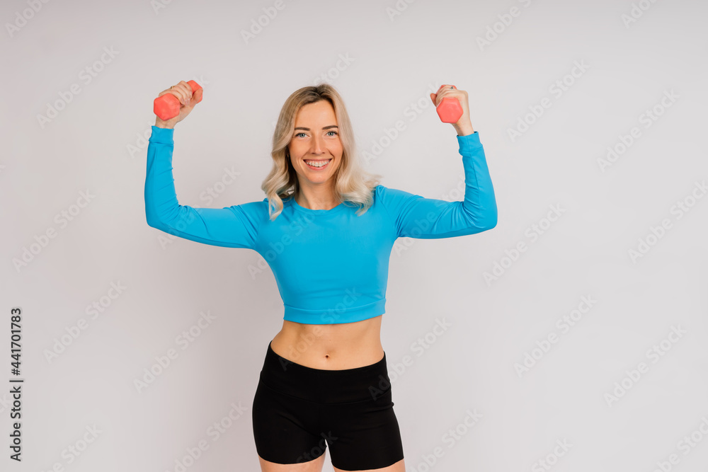 Sporty girl doing exercise with dumbbells, silhouette studio shot over ...