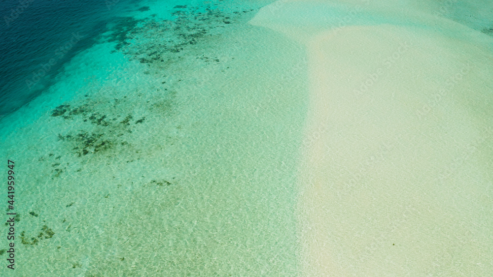 White sandy beach in the lagoon with turquoise water on a tropical ...