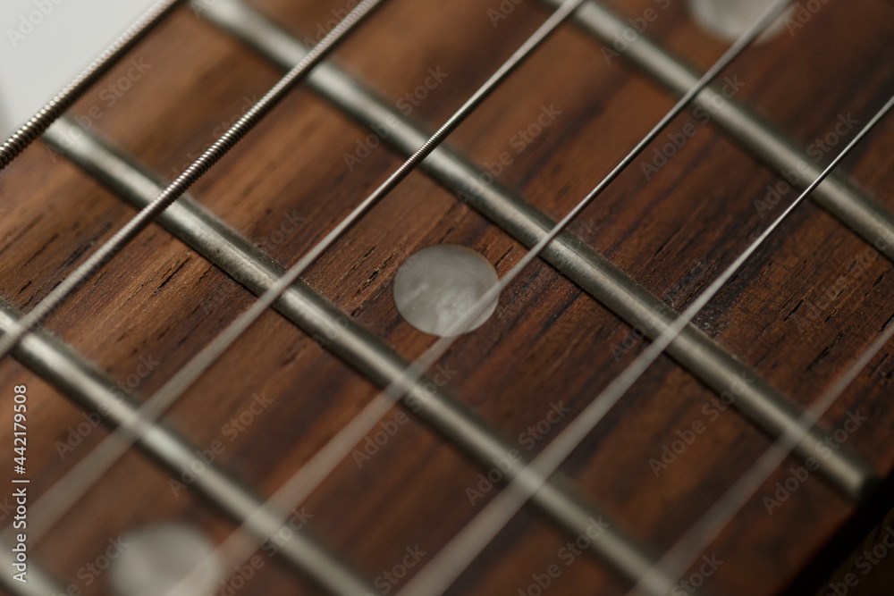 Electrical guitar neck, fretboard and metal strings closeup. Electric ...