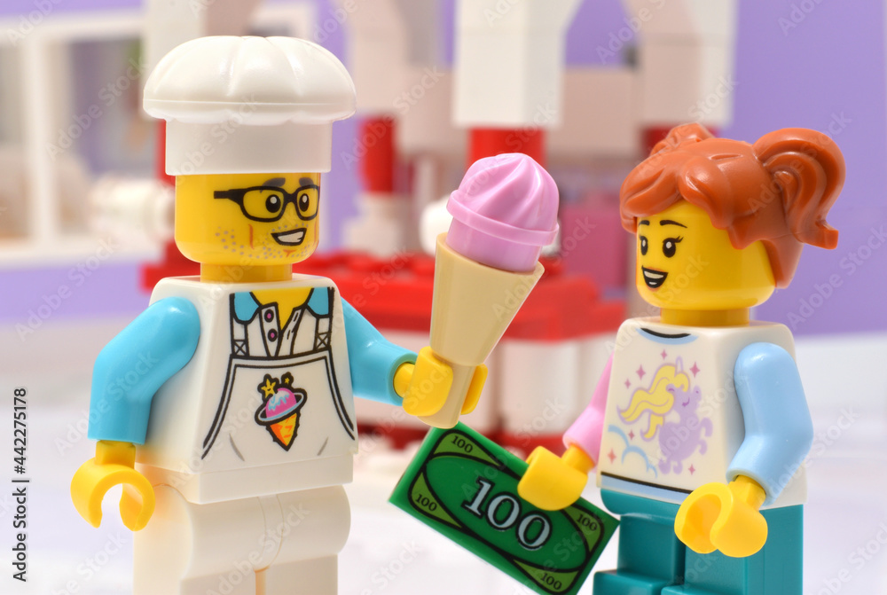 Lego minifigure ice cream salesman and young girl is paying money ...