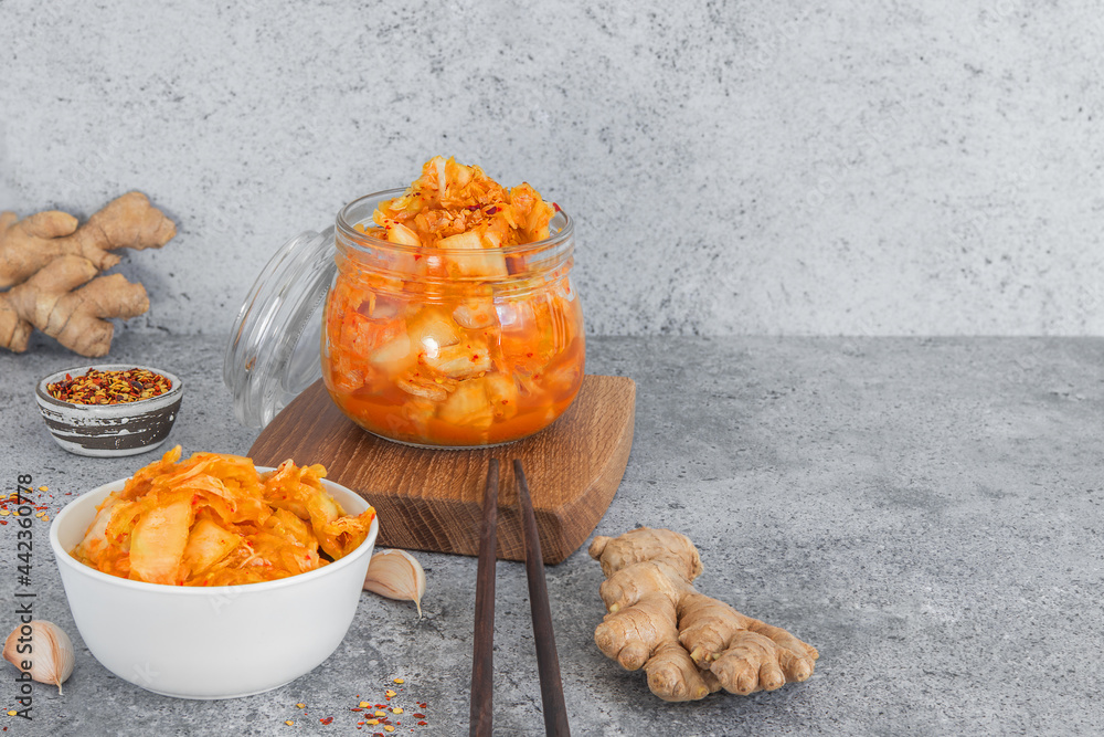 Probiotics fermented food kimchi cabbage in a glass jar and salad bowl ...