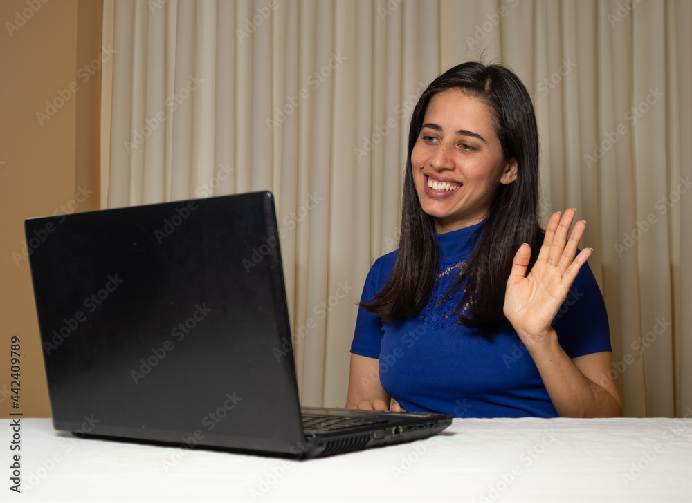 waving to laptop, left handed, right hand. woman working on laptop ...