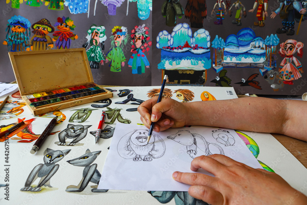 The animator draws with a pencil and draws characters from cartoons ...