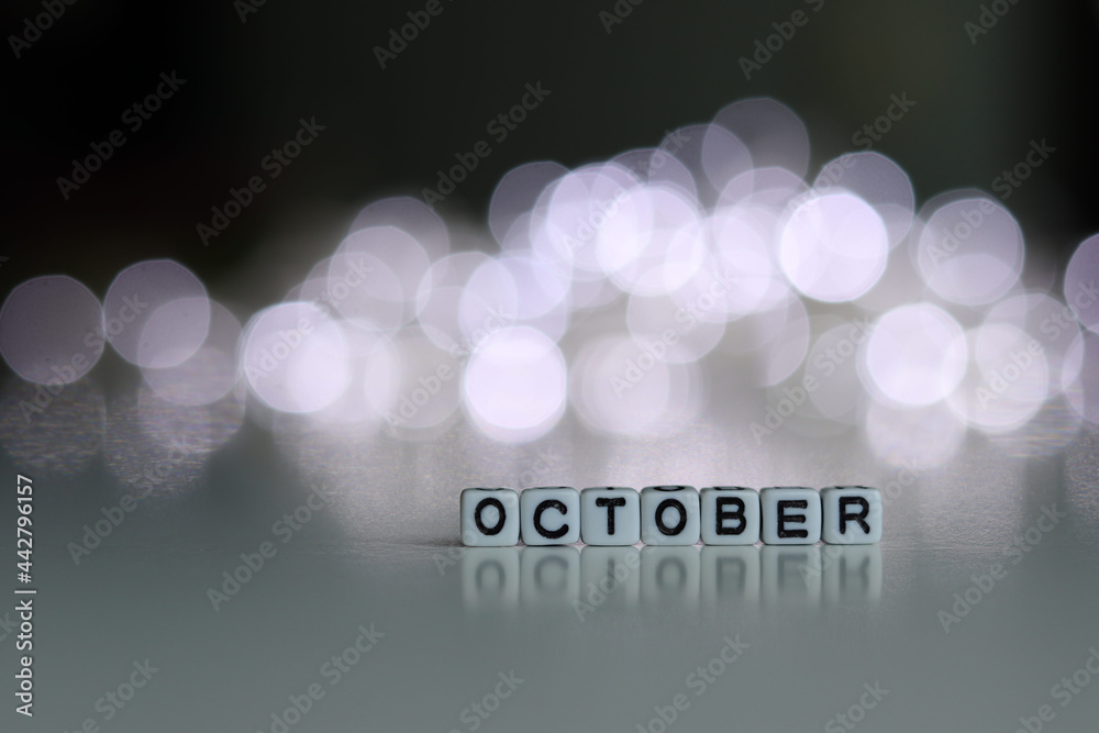 OCTOBER text on white cubic blocks. The letters are written on the ...