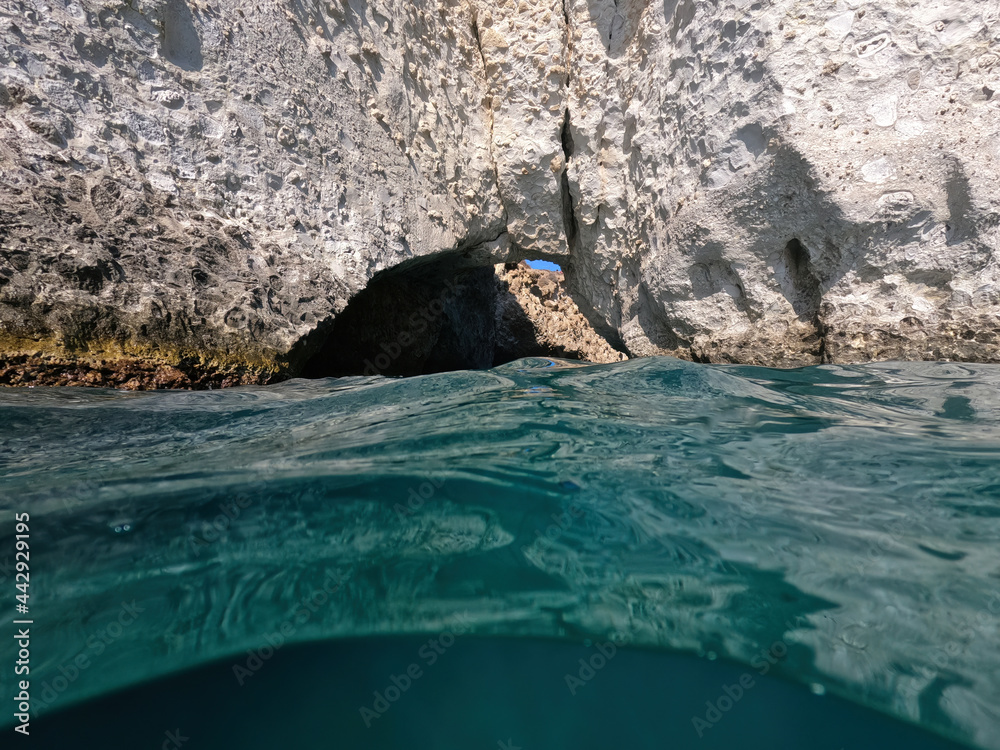 Underwater sea level split photo of iconic caves of Sarakiniko a ...