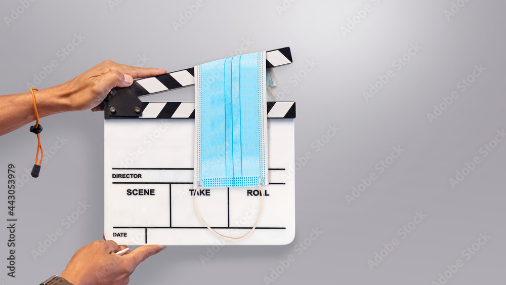 Hand holding film slate with the protective face mask. its uses in film ...
