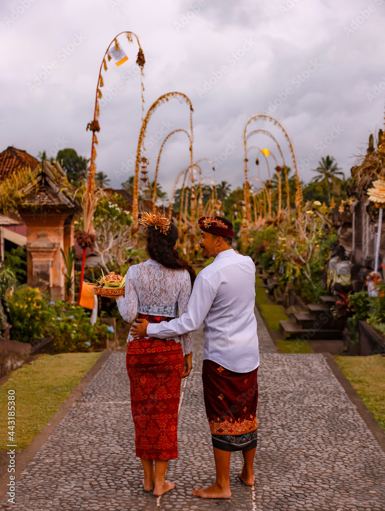 Balinese ceremony. Multicultural couple going to Hindu religious ...