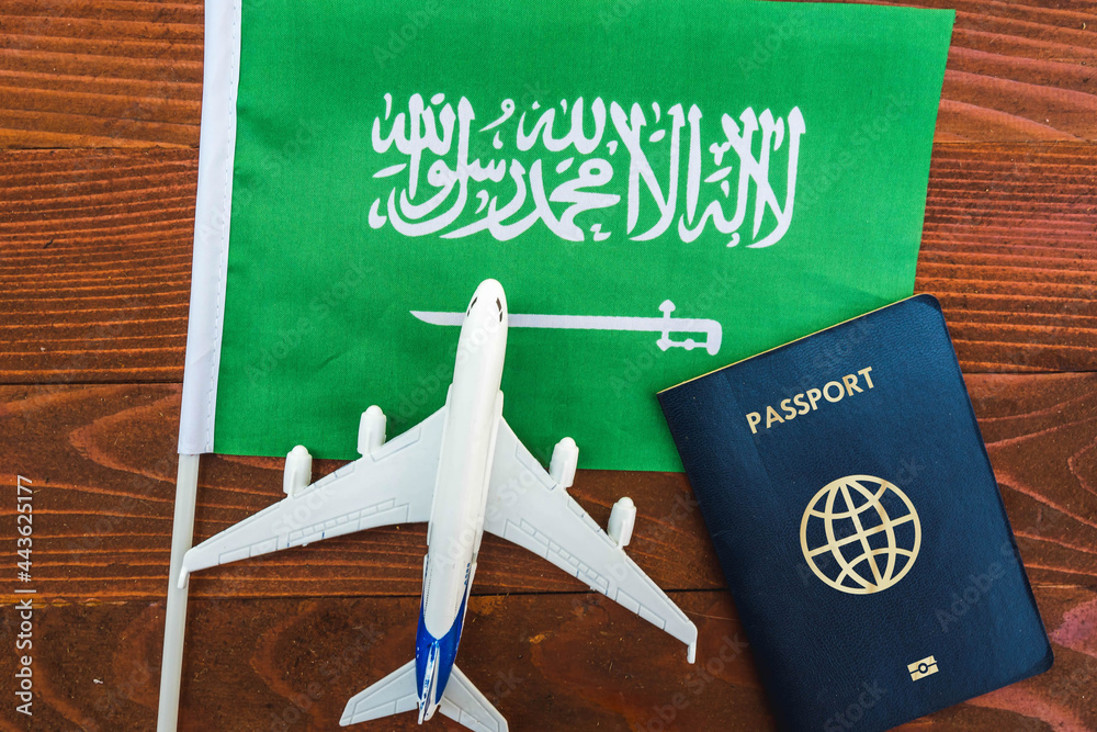 Flag of Saudi Arabia with passport and toy airplane on wooden ...