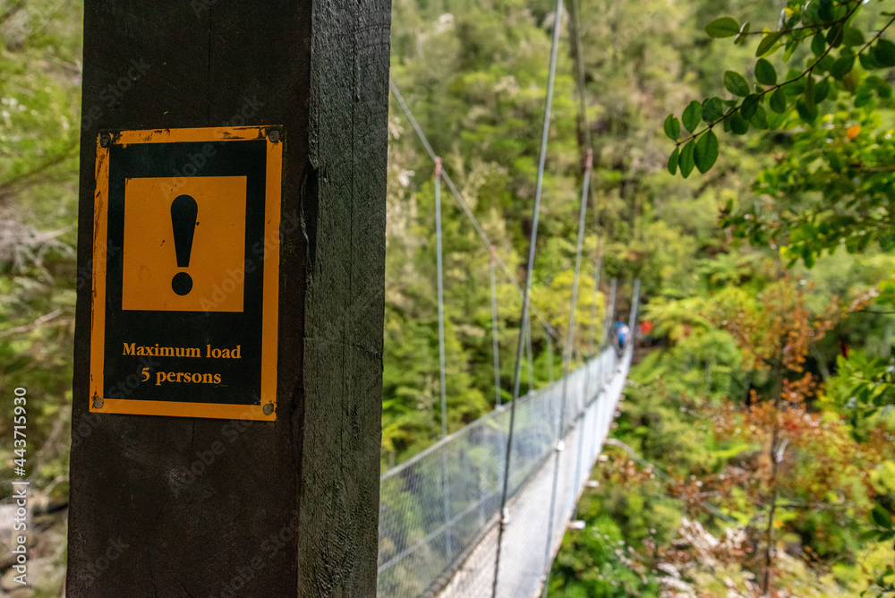 Warning signs about a suspension footbridge in Abel Tasman Cost Track ...