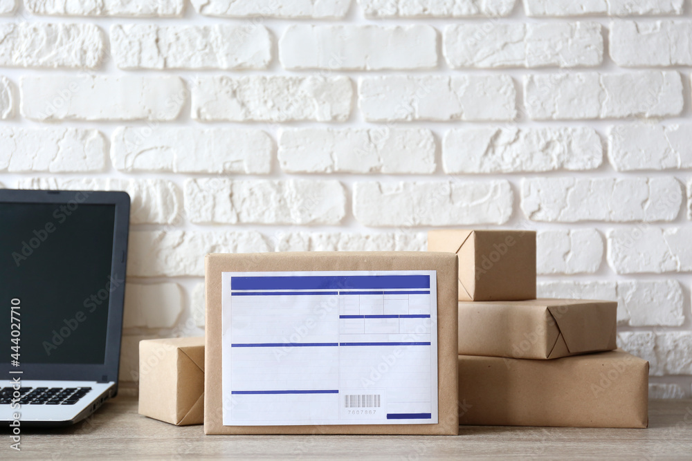 Stacked packages of different sizes wrapped in craft paper with ...