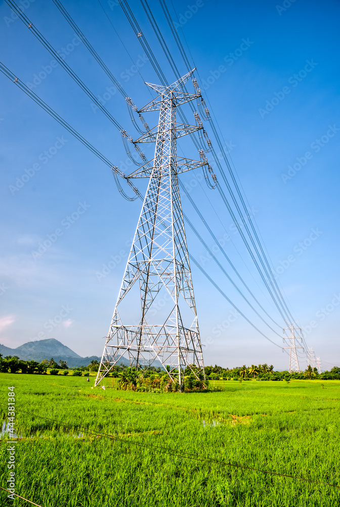 Overhead eletrical transmission line crossing the rice field at ...