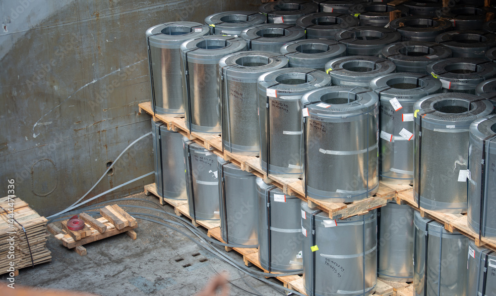 Loading of galvanized steel coils in cargo hold of cargo ship. Stock ...