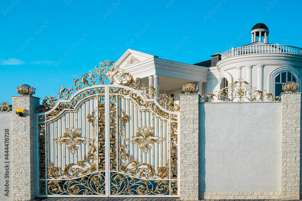 Chic gate with gold elements in the mansion. Beautiful handmade gate in ...