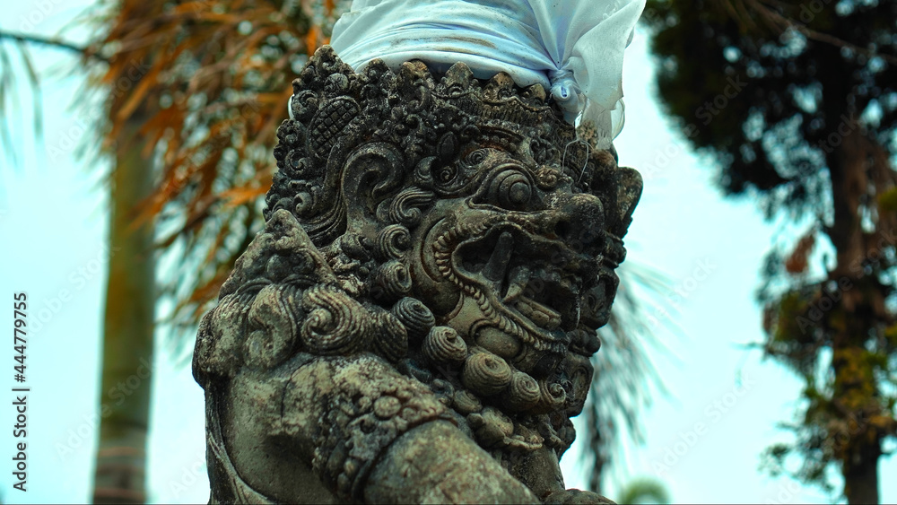 old Indonesian ethnic stone statue of an evil demon with an open mouth ...