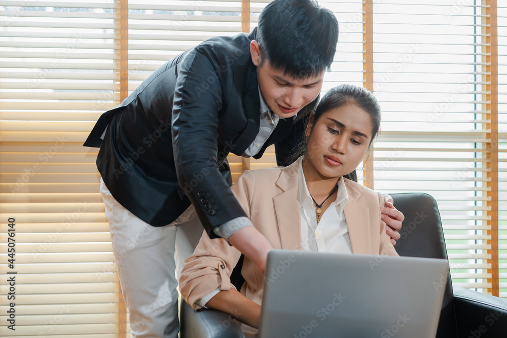 Unhappy asian young employee, employer colleague or boss touching at ...