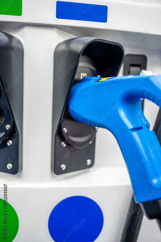 The electric vehicle charging gun is inserted into the socket of the ...
