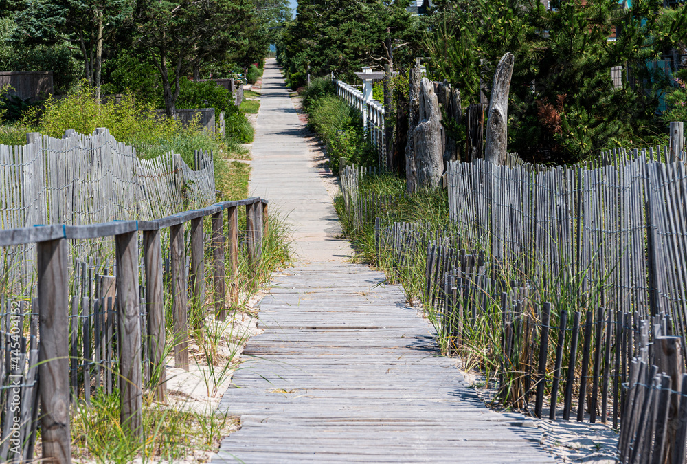 Walkway over sand dunes into the neighborhoods on Fire Island Stock ...