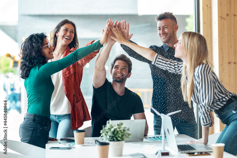 Group of successful smart business team celebrating good job while ...