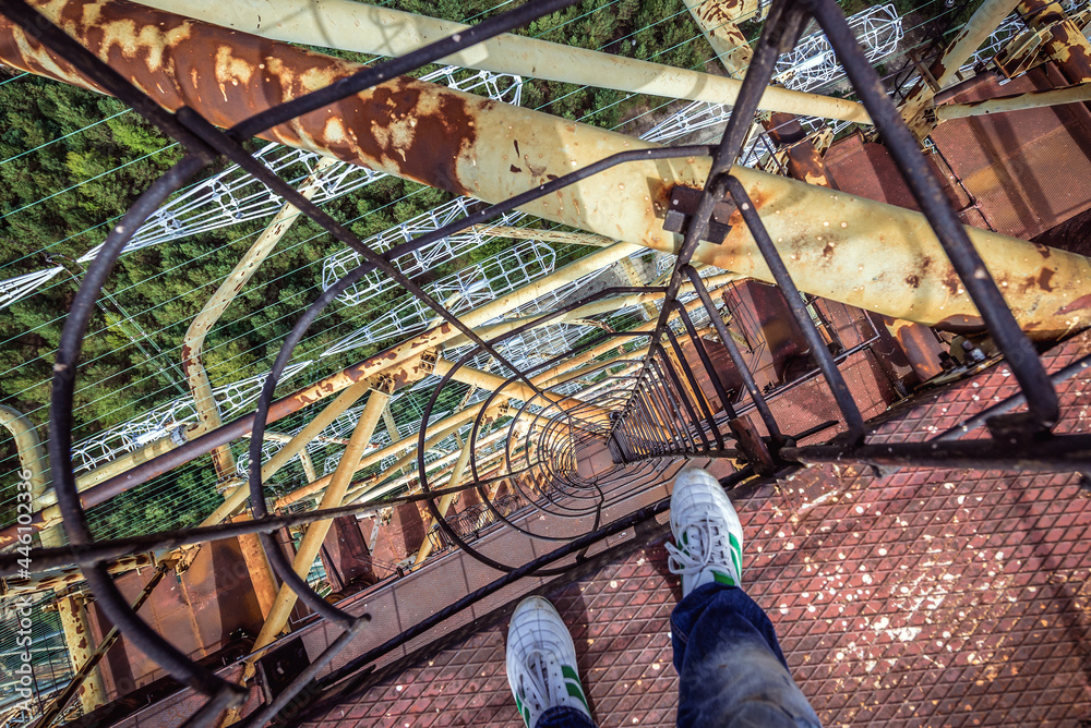 Tourist climbing on old Soviet Duga radar in abandoned military base in ...