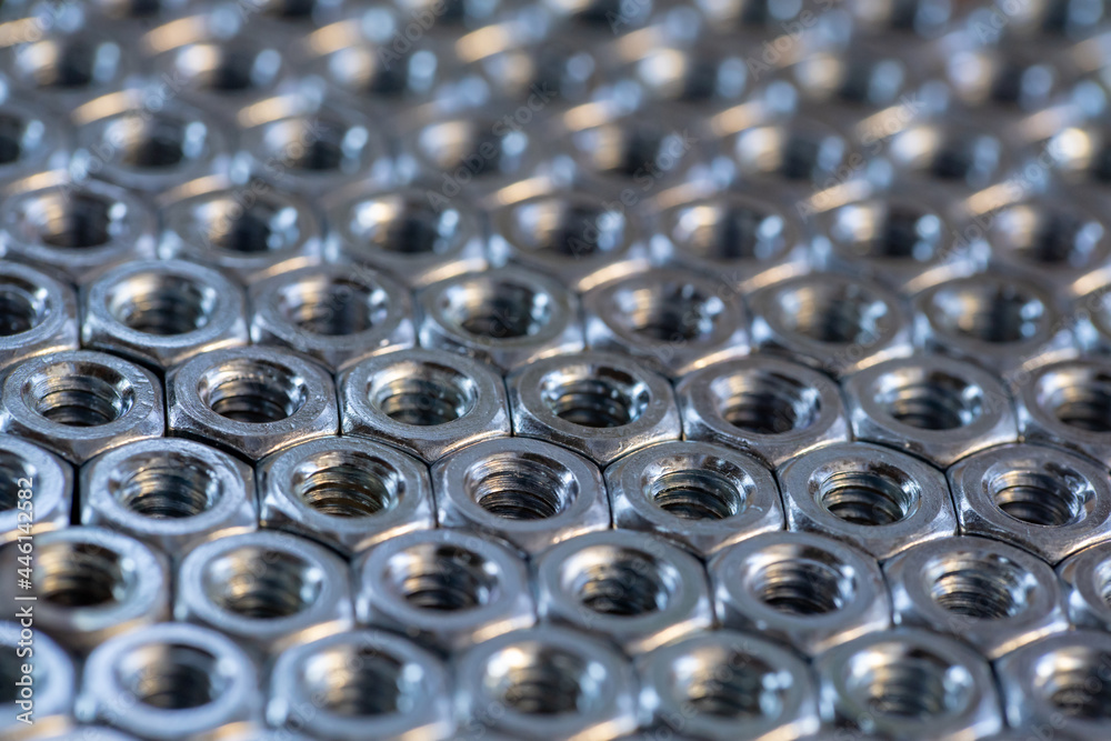 pattern of aligned bolt nuts. macro photography. blurred background ...