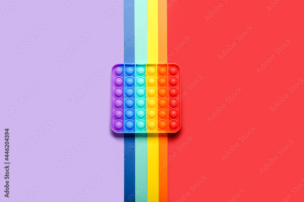 Rainbow pop it fidget toy on color background Stock Photo | Adobe Stock