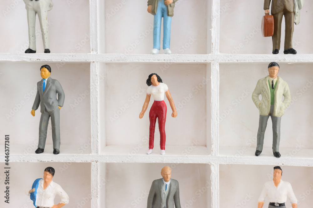 Miniature woman and a group of miniature men. concept of gender ...