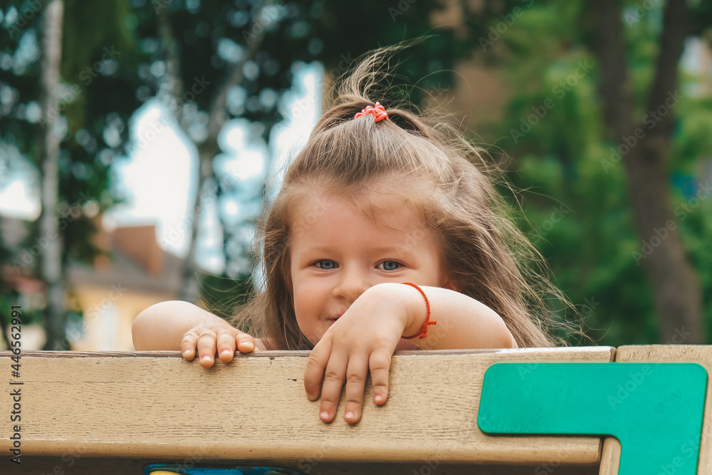 Kid on obstacle course. Pretty happy young girl playing outside in ...